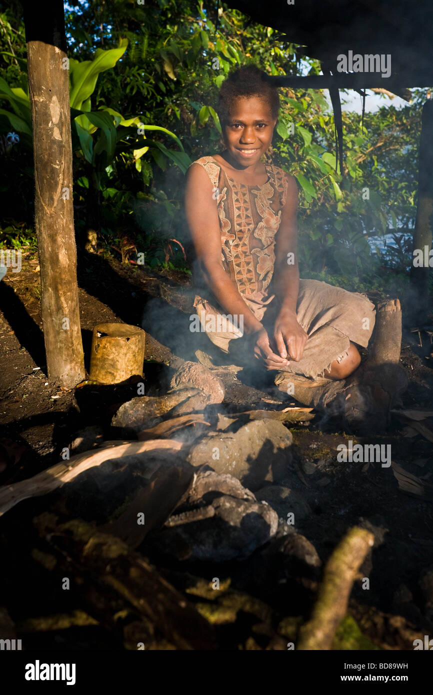 A local family cooking wild pig by Lake Letas on Gaua Vanuatu Stock ...