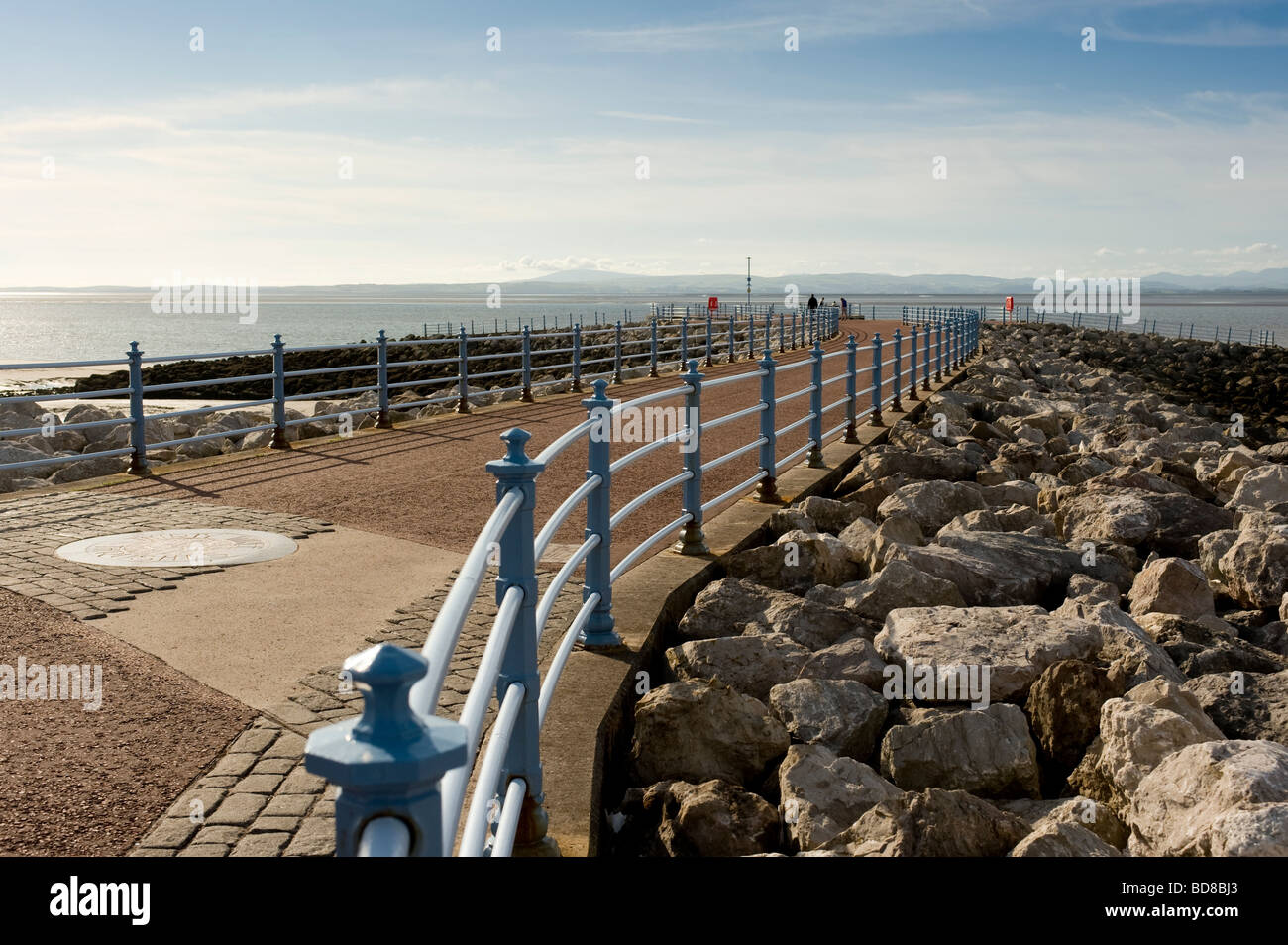 Stone Jetty looking towards the sea with unidentifiable figures in the ...