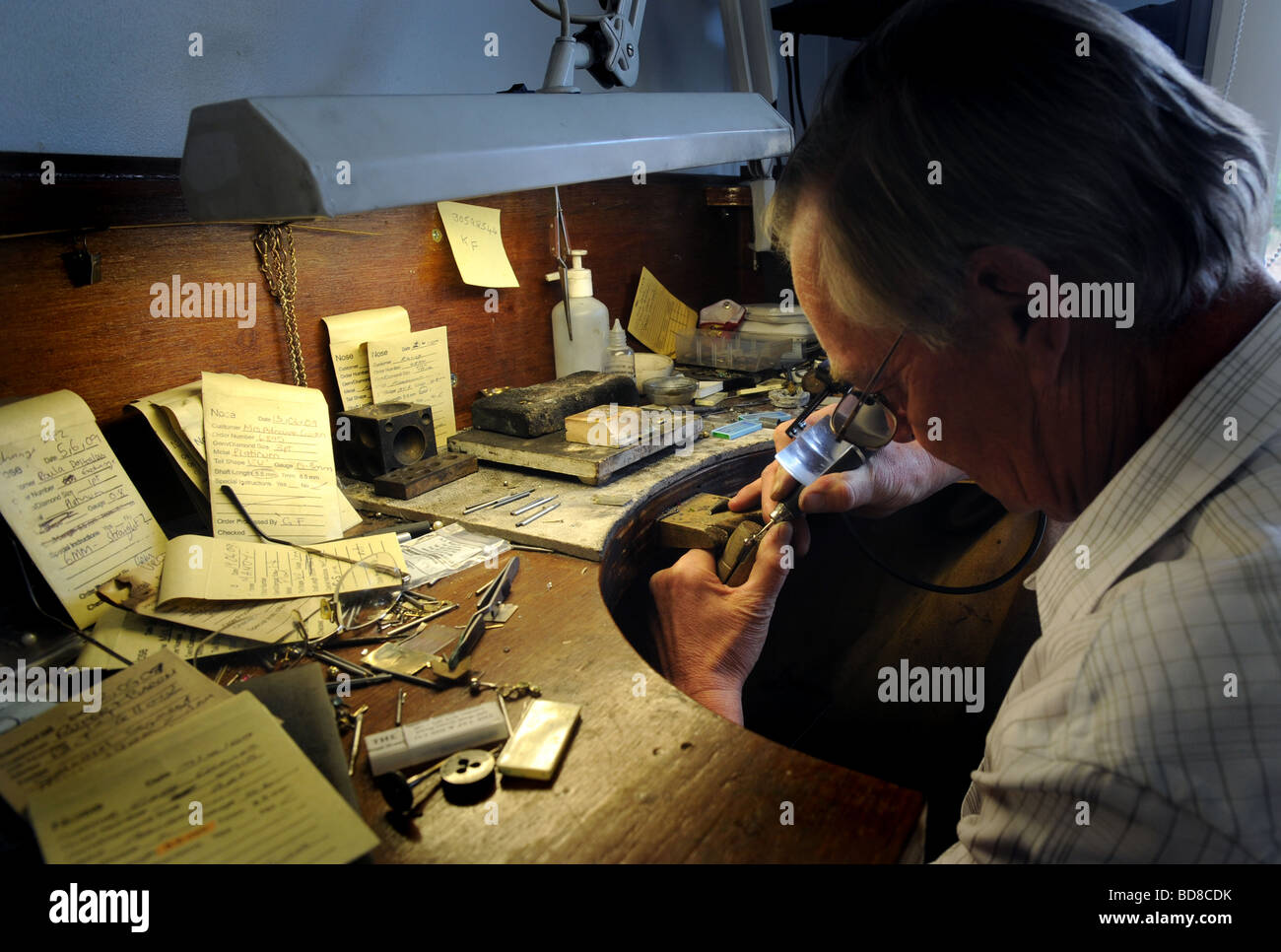 A Goldsmith at work on a diamond stud Stock Photo - Alamy