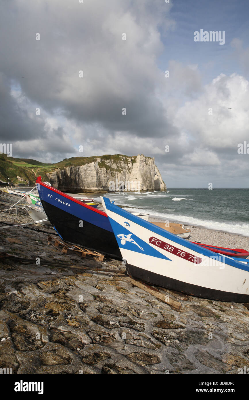 Fishing boats on the beach at Etretat in Normandy with the cliffs and ...
