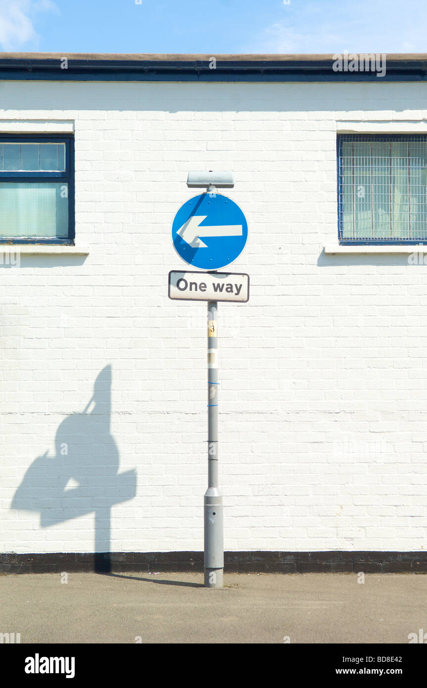 One way sign against white wall Stock Photo - Alamy