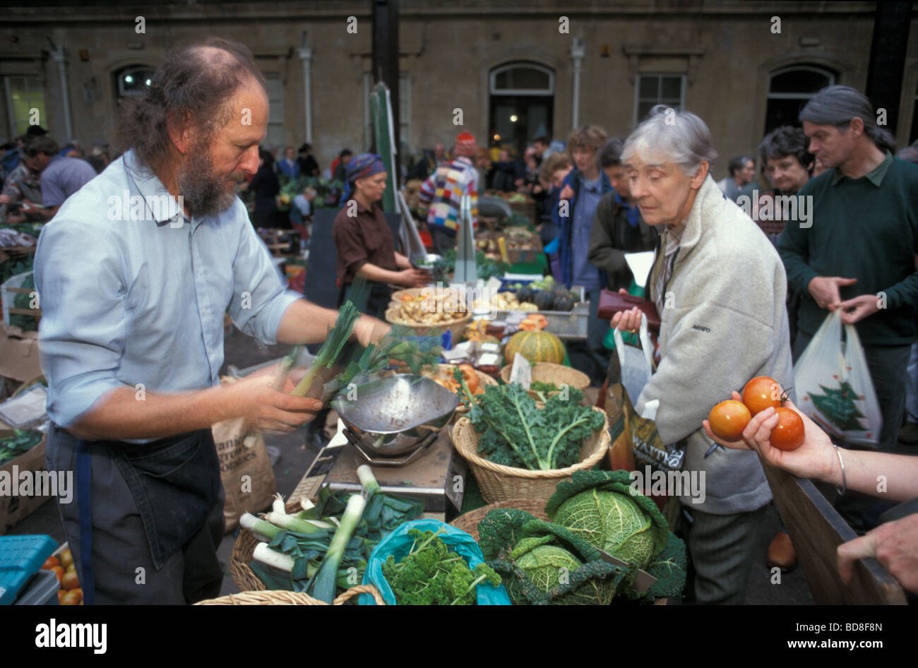 Bath Farmers Market stalls and members of the public buying fruit and ...