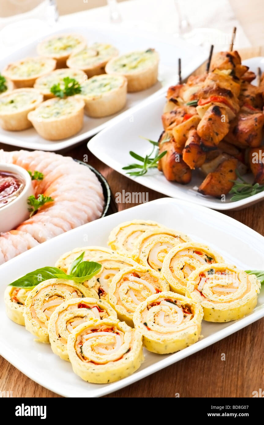 Many dishes of bite size appetizers and party food Stock Photo - Alamy