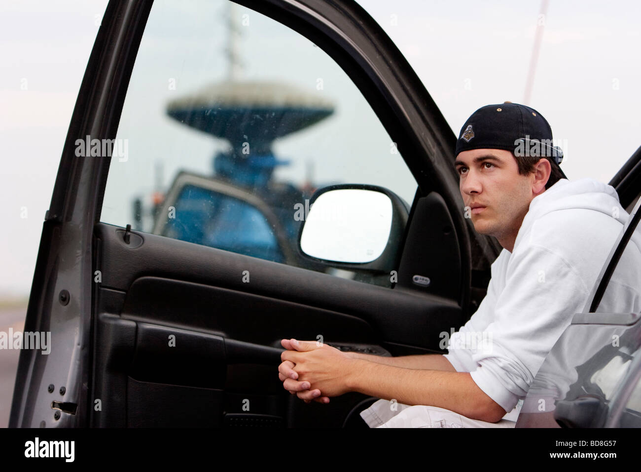 Storm chaser Andrew Arnold watchs a storm in southern Kansas from a ...