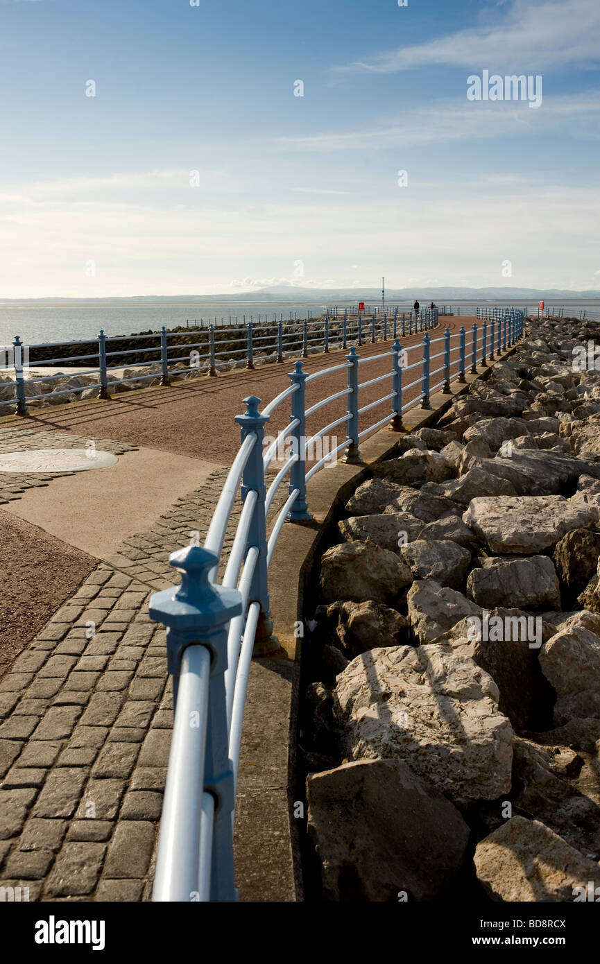 Stone Jetty looking towards the sea with unidentifiable figures in the ...