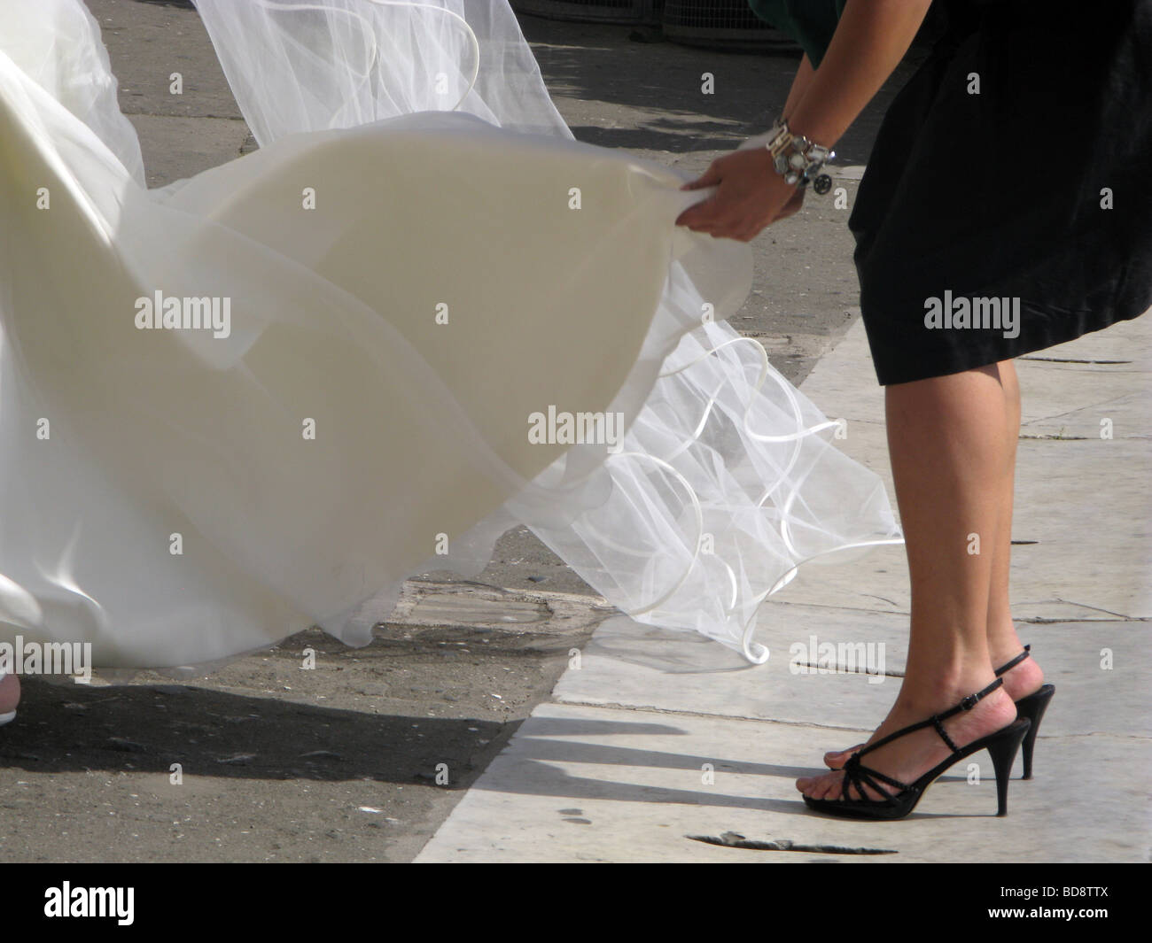 wedding bride and friend in street Stock Photo - Alamy
