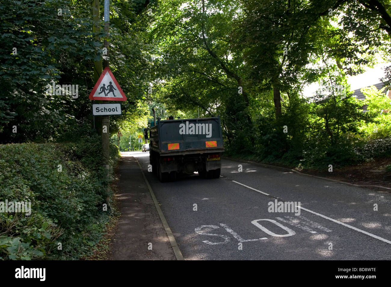 A heavy goods vehicle travelling past a school patrol slow down road ...