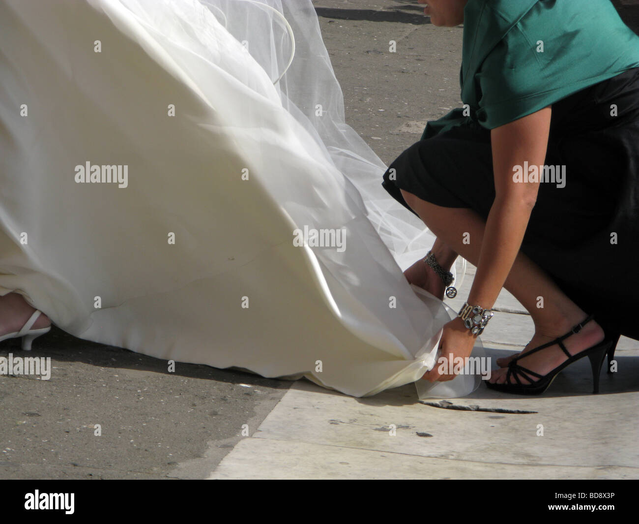 wedding bride and friend in street Stock Photo - Alamy