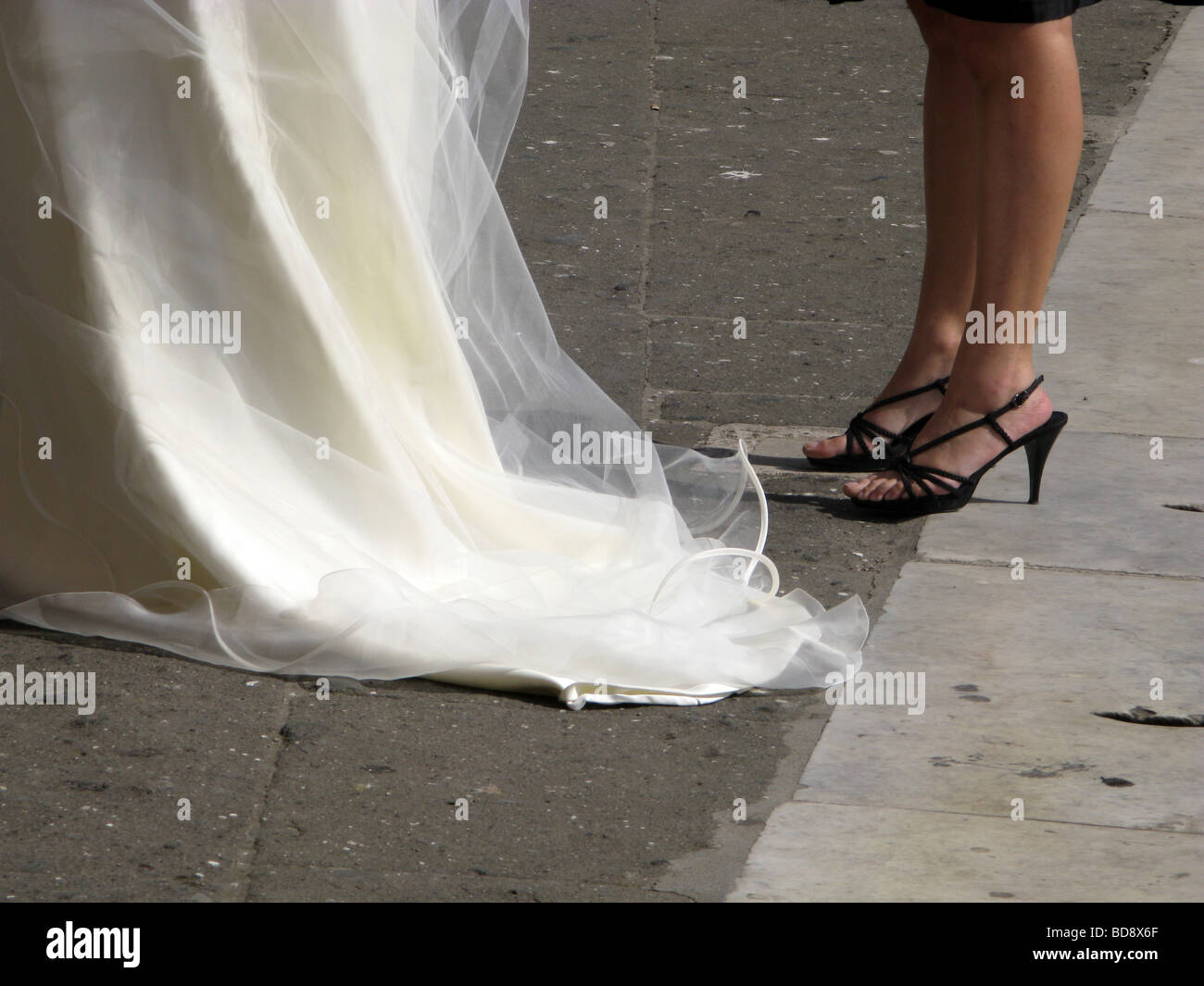 wedding bride and friend in street Stock Photo - Alamy