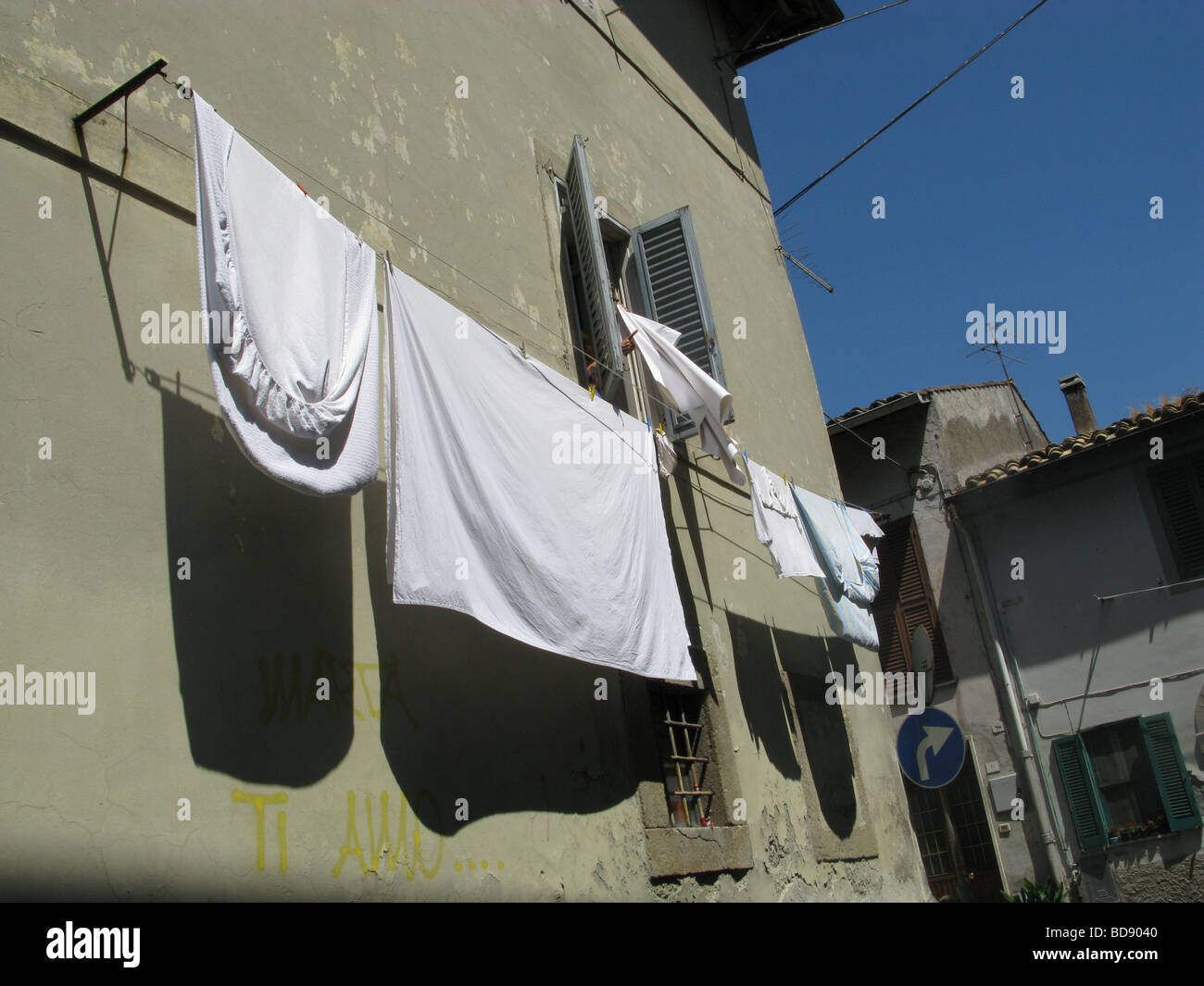 bed sheets on washing line outdoors in sun in italy Stock Photo - Alamy