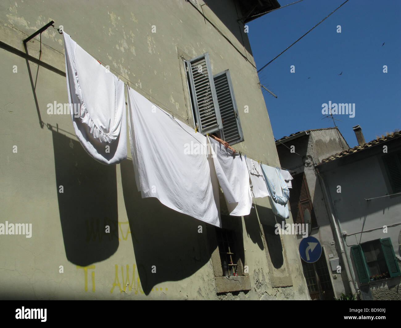 bed sheets on washing line outdoors in sun in italy Stock Photo - Alamy
