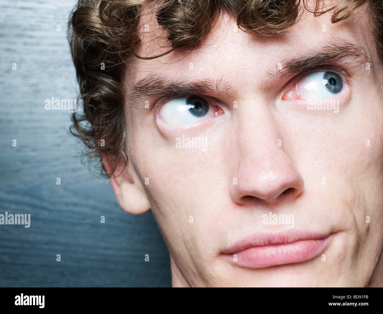 Young man with large eyes Stock Photo - Alamy