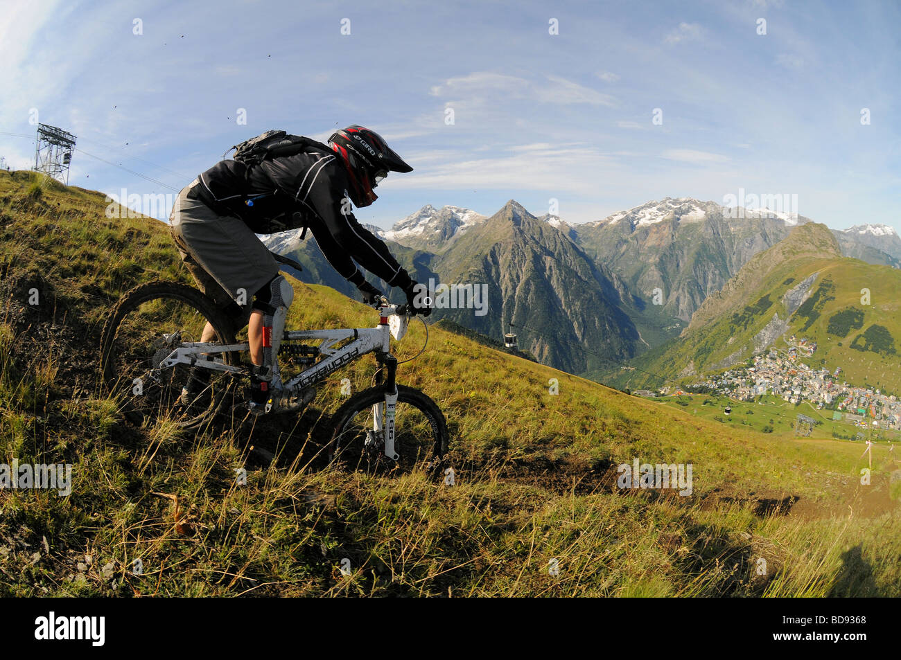 A mountain biker races downhill competing in the MTB Enduro of Nations ...