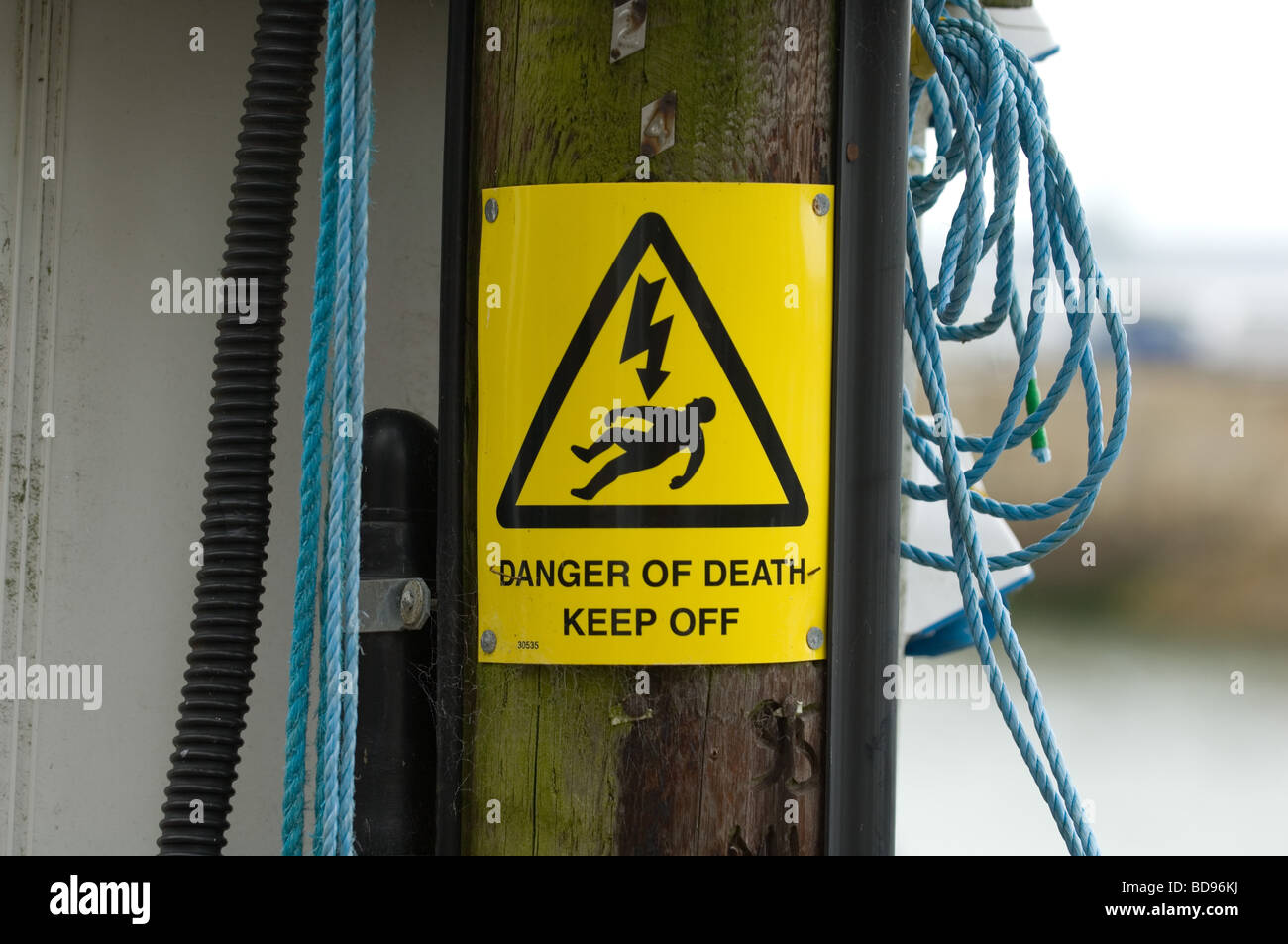 Electrical danger sign on telephone post Stock Photo - Alamy