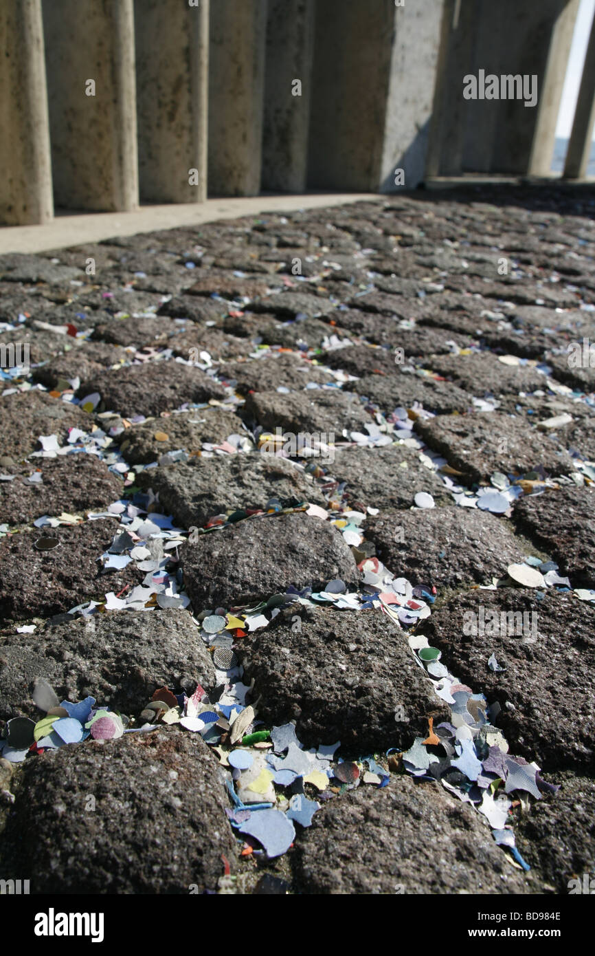 lots of colourful confetti and garlands on paved street road in sun ...