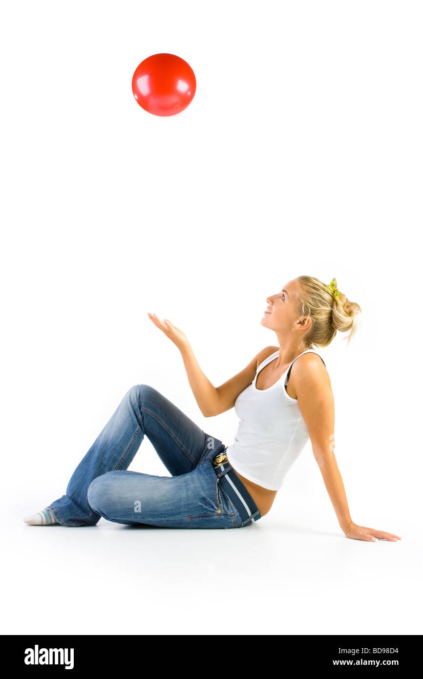 Blonde girl throwing red ball in fitness gym isolated on white ...