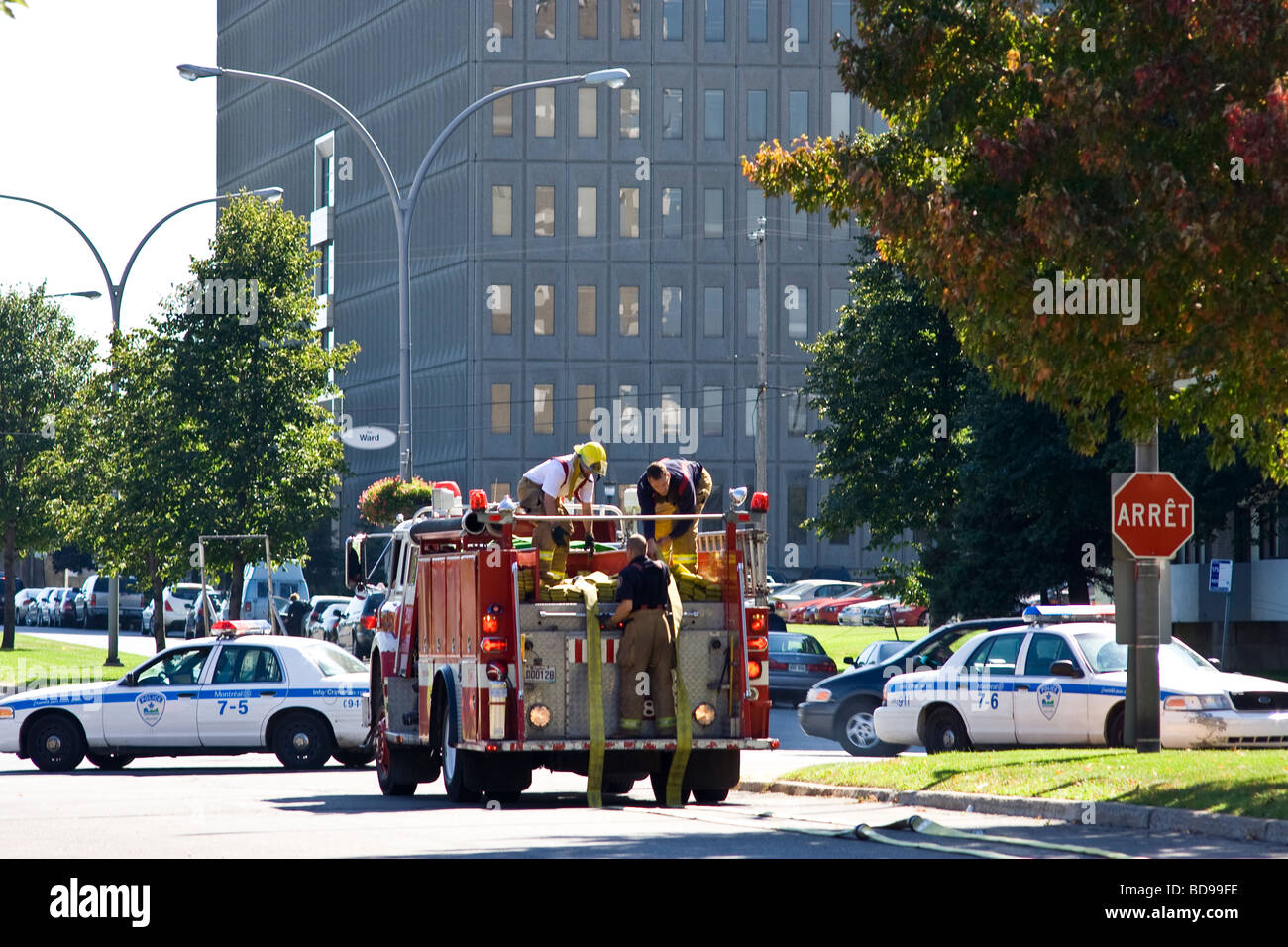 Firefighters rolling the hose Stock Photo - Alamy