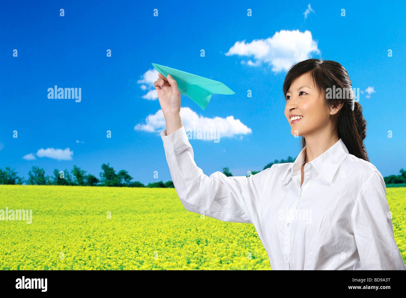Chinese girl playing paper airplane in the field Stock Photo - Alamy