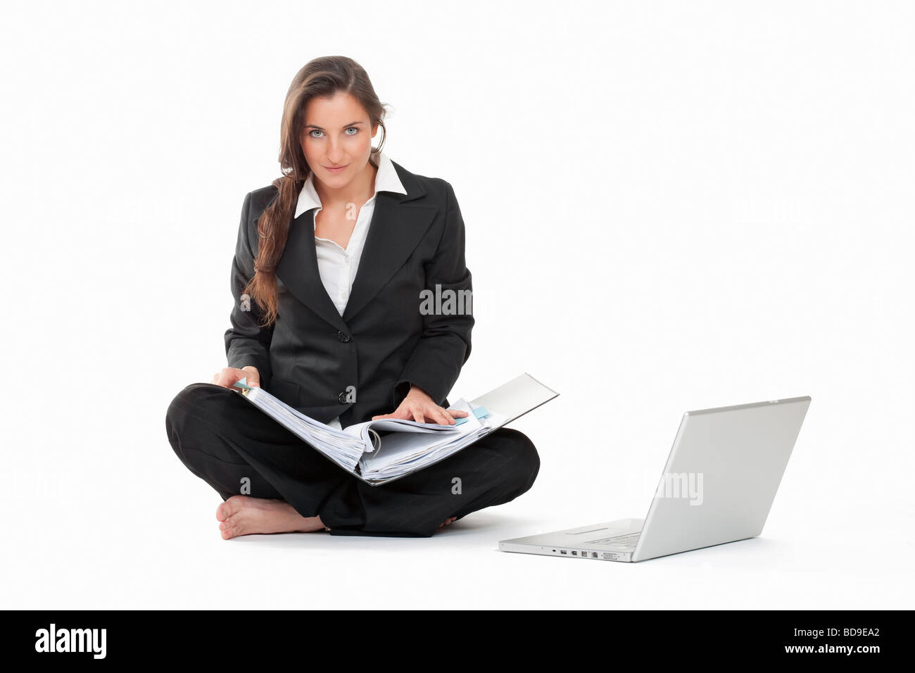attractive young businesswoman working with laptop computer and files ...