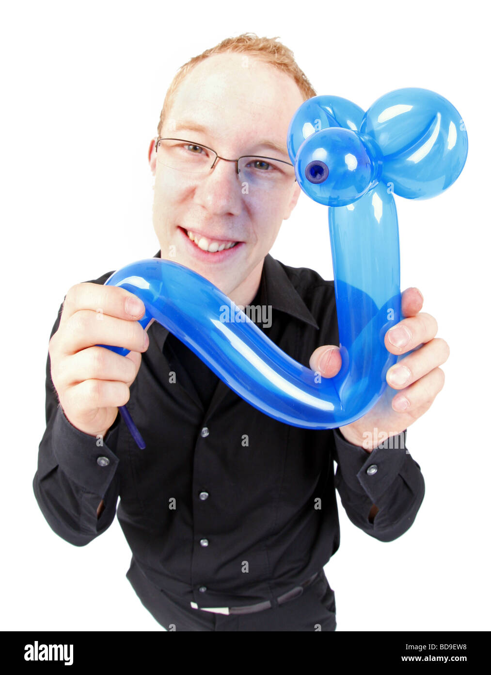 young magic tinkering a balloon animal with balloons Stock Photo - Alamy