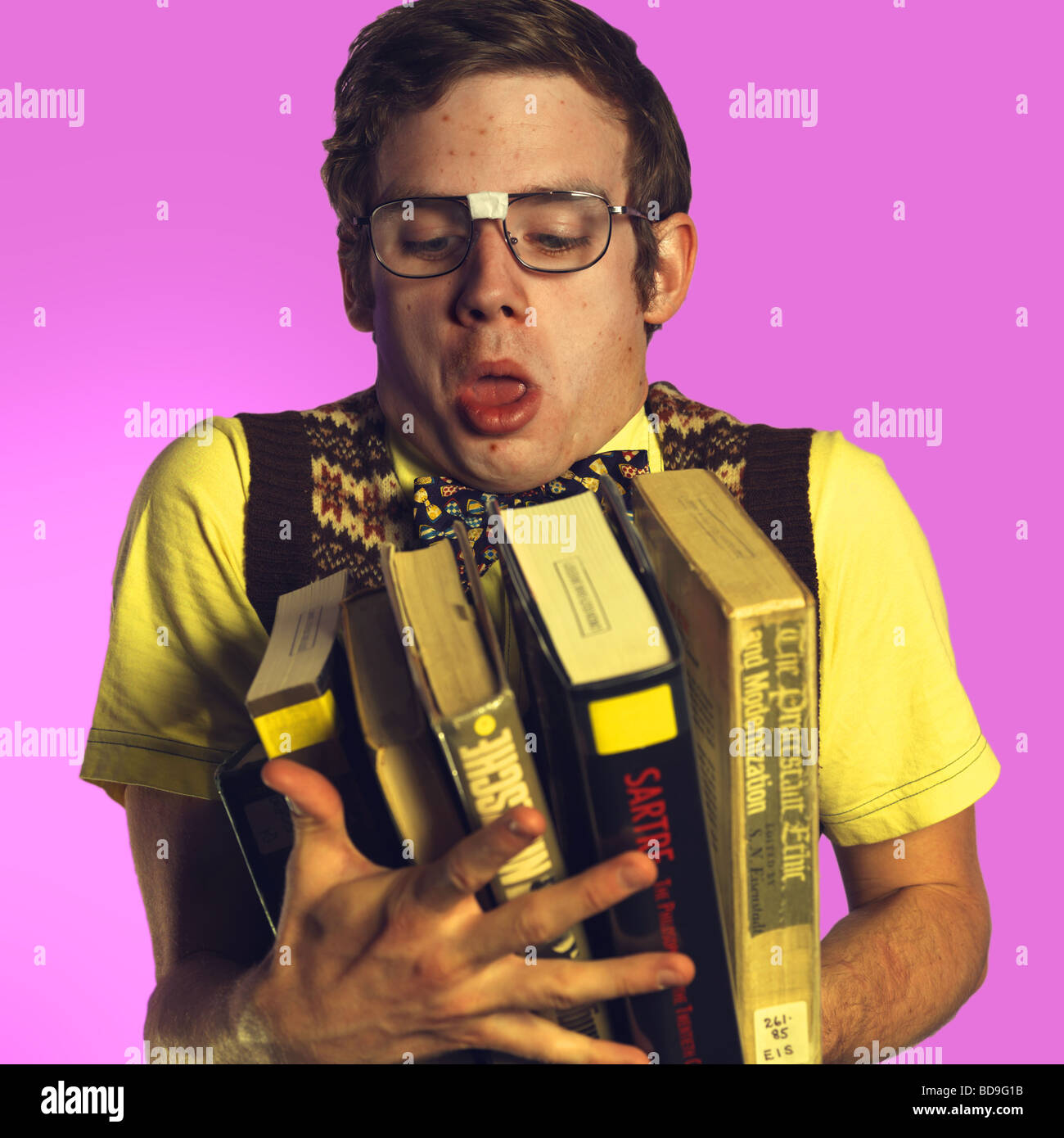 Nerdy teenager wearing glasses dropping his library books Stock Photo ...