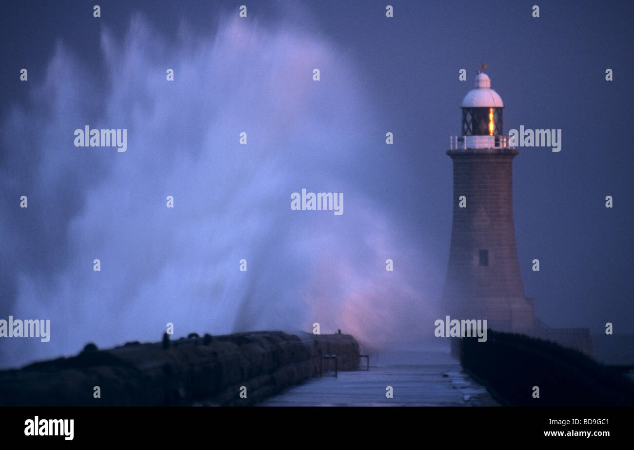 Huge waves break over the pier and lighthouse at Tynemouth, England ...