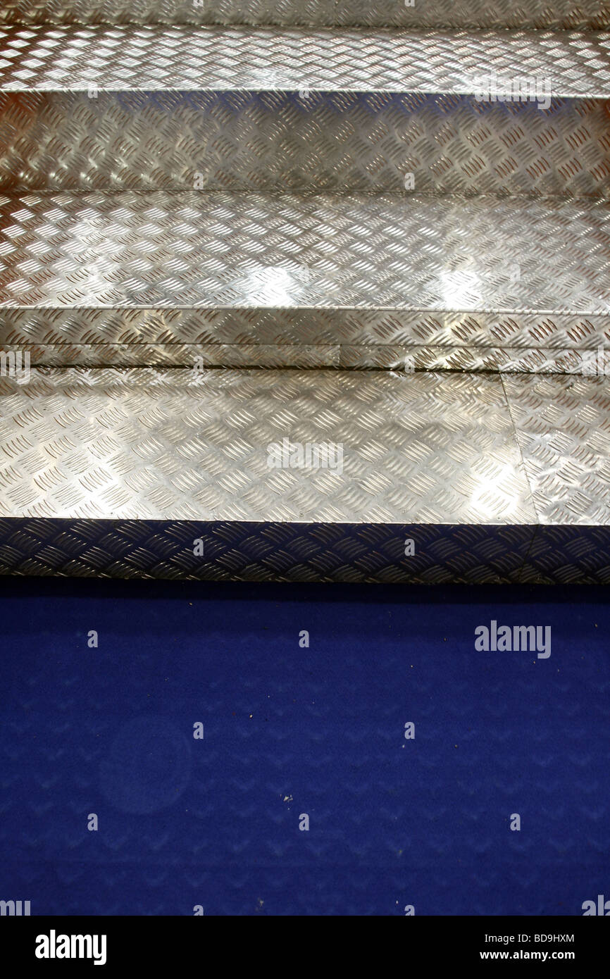 empty metal steps and blue carpet in exhibition hall Stock Photo - Alamy