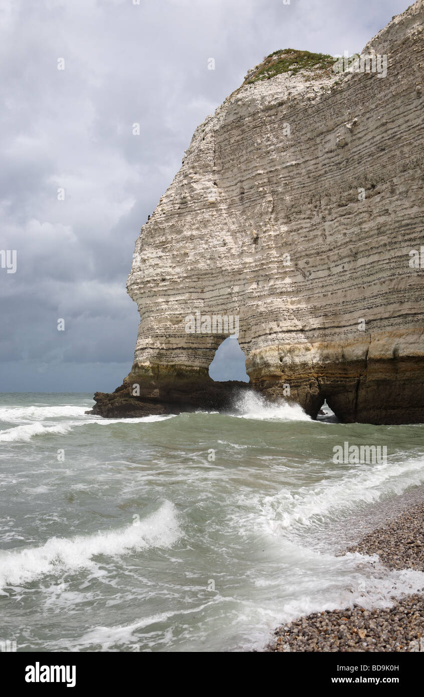 Waves breaking against the limestone cliffs at Etretat, Normandy. The ...