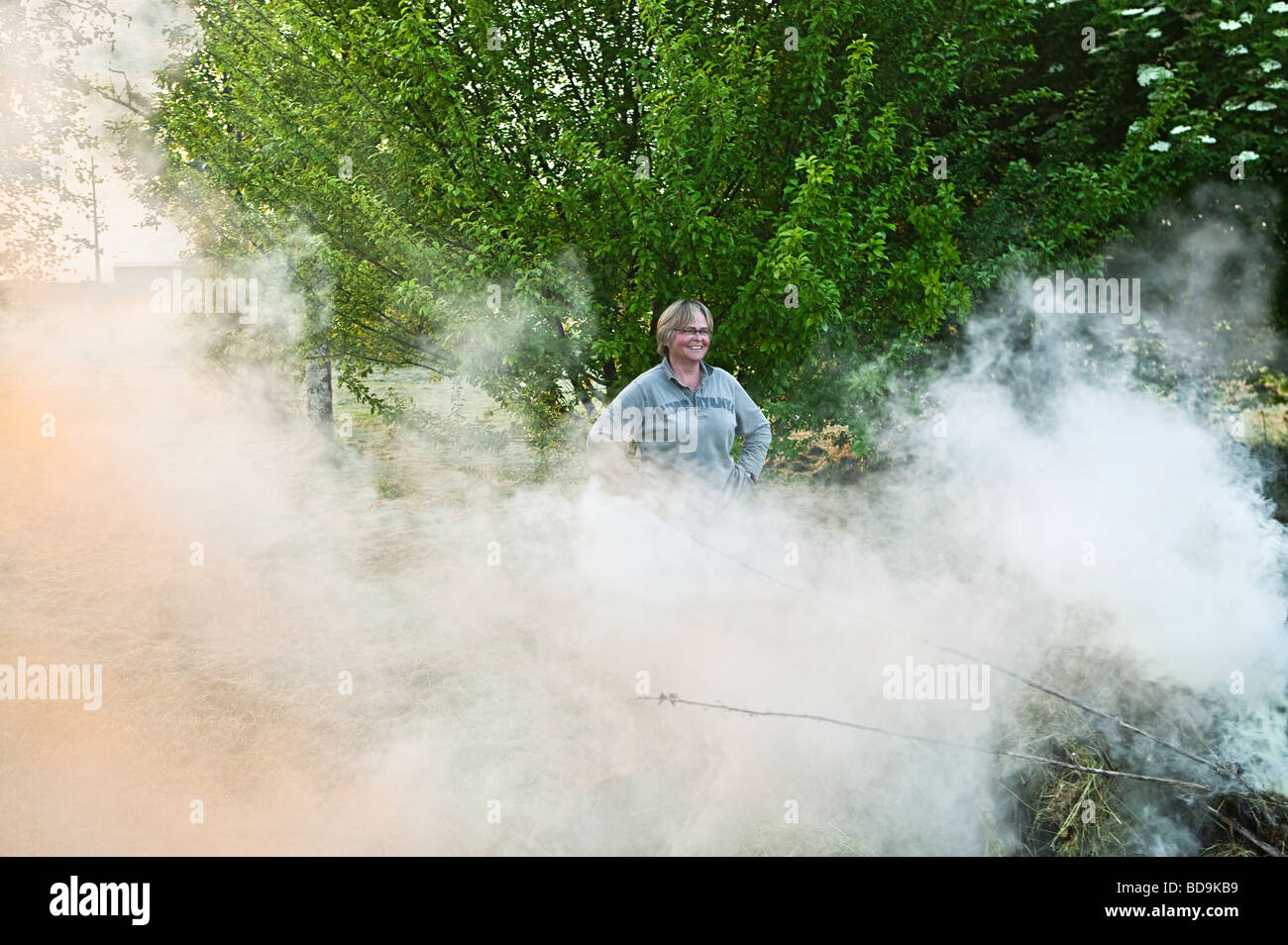 Portrait of a woman standing in smoke Stock Photo - Alamy
