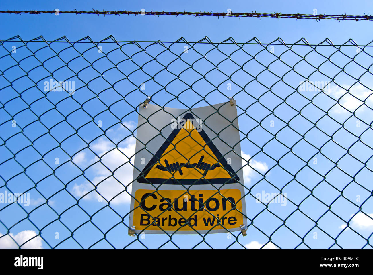 caution barbed wire sign on a fence at chiswick polytechnic stadium ...