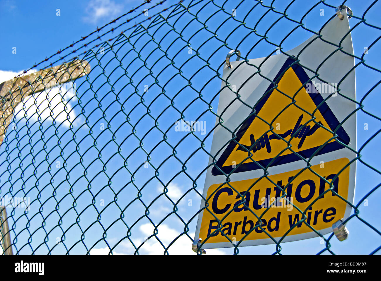 caution barbed wire sign on a fence at chiswick polytechnic stadium ...