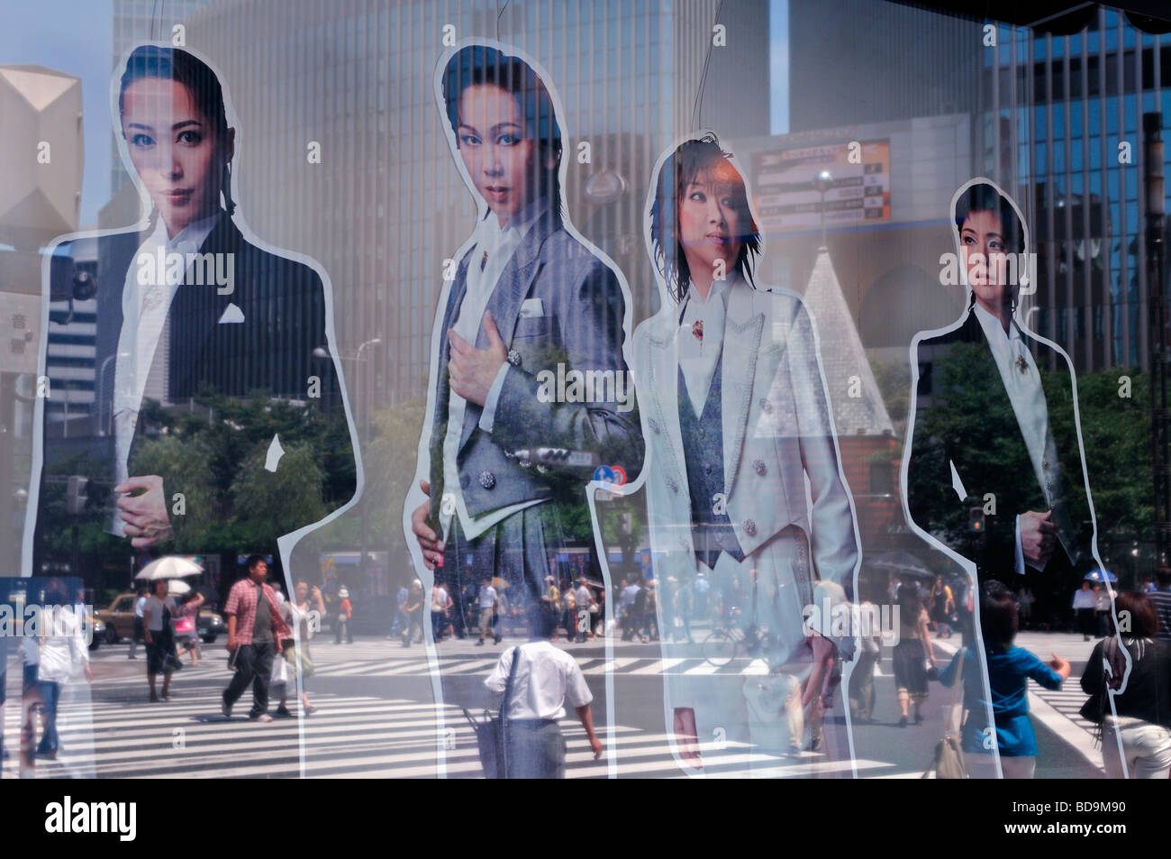 Pedestrians are reflected in a shop window in Ginza district Central ...