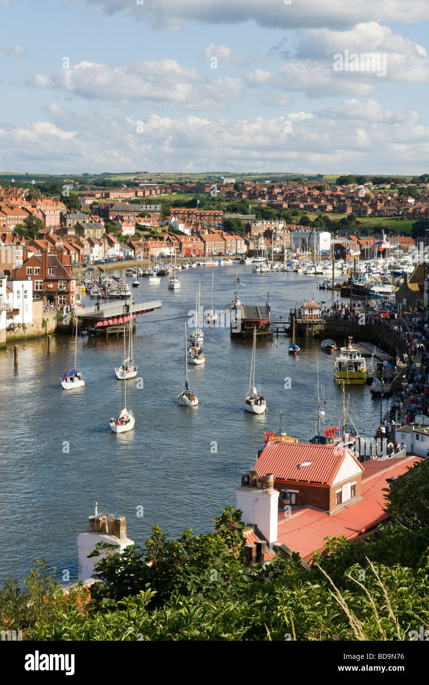 Boats pass through the open Swing Bridge at high tide in Whitby North ...