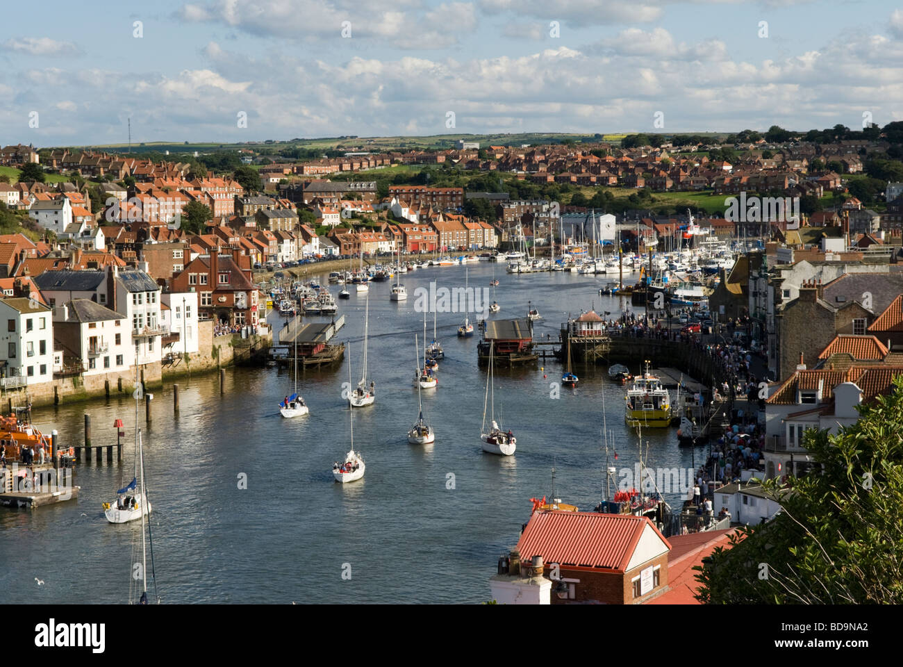 Boats pass through the open Swing Bridge at high tide in Whitby North ...