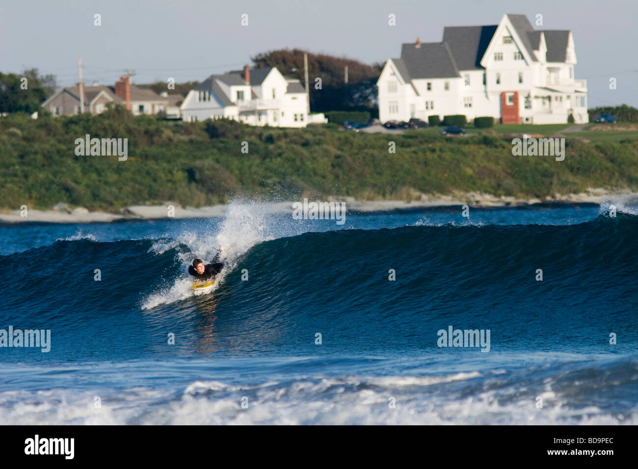 A surfer launches from a wave on Newport's first Beach in Rhode Island ...