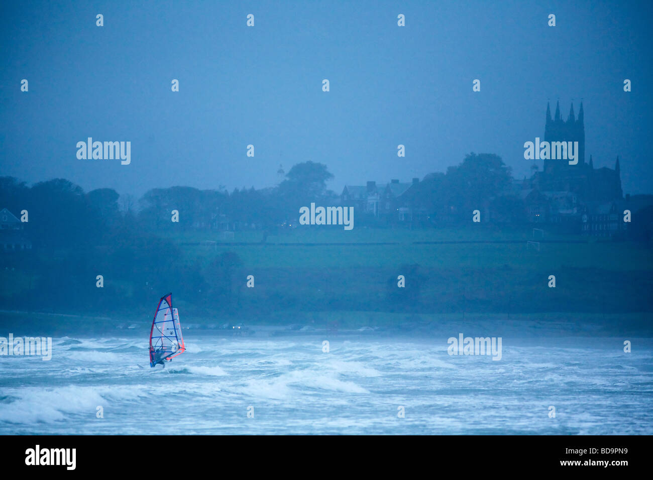 Two wind surfers catching a windy dusk ride off of Sachuest beach rhode ...