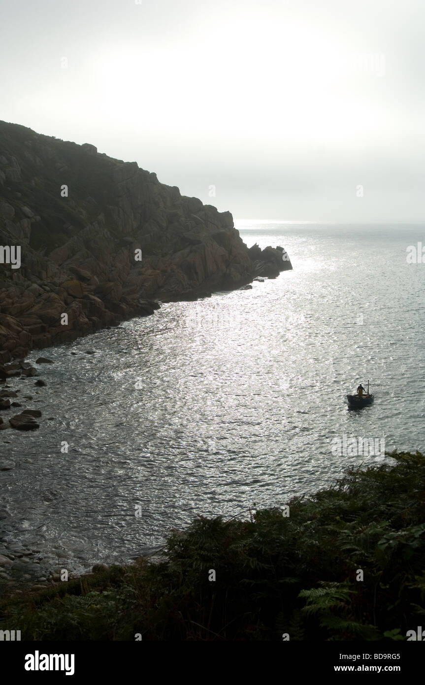 A single lobster boat and fisherman out at sea off Penberth Cove ...