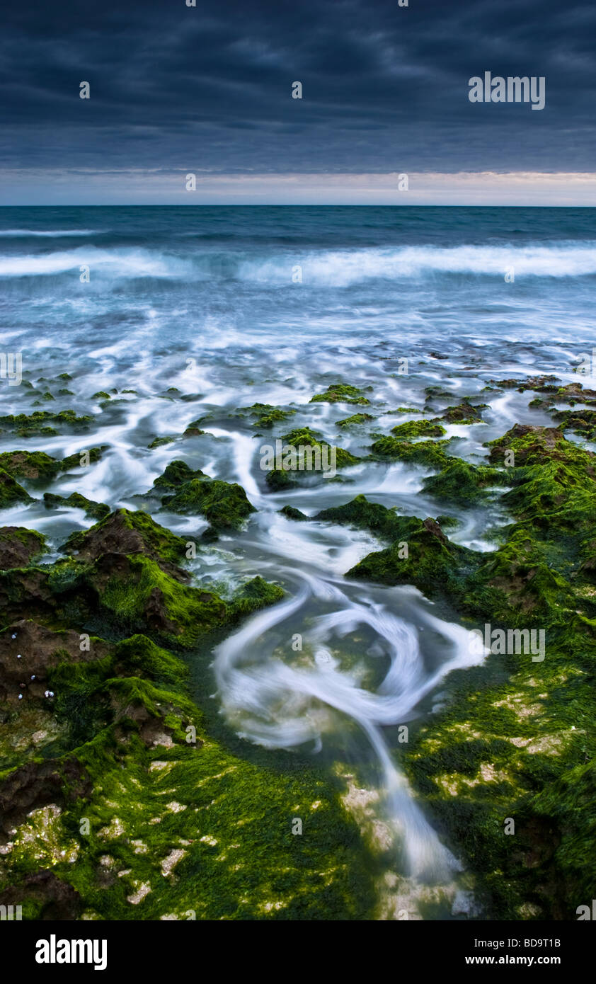 A wave swirling around a rock pool at Waterman's Beach in Perth ...