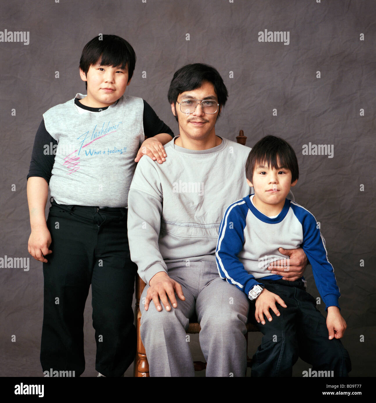 Color studio portrait of Inuit father and two children in a photography ...