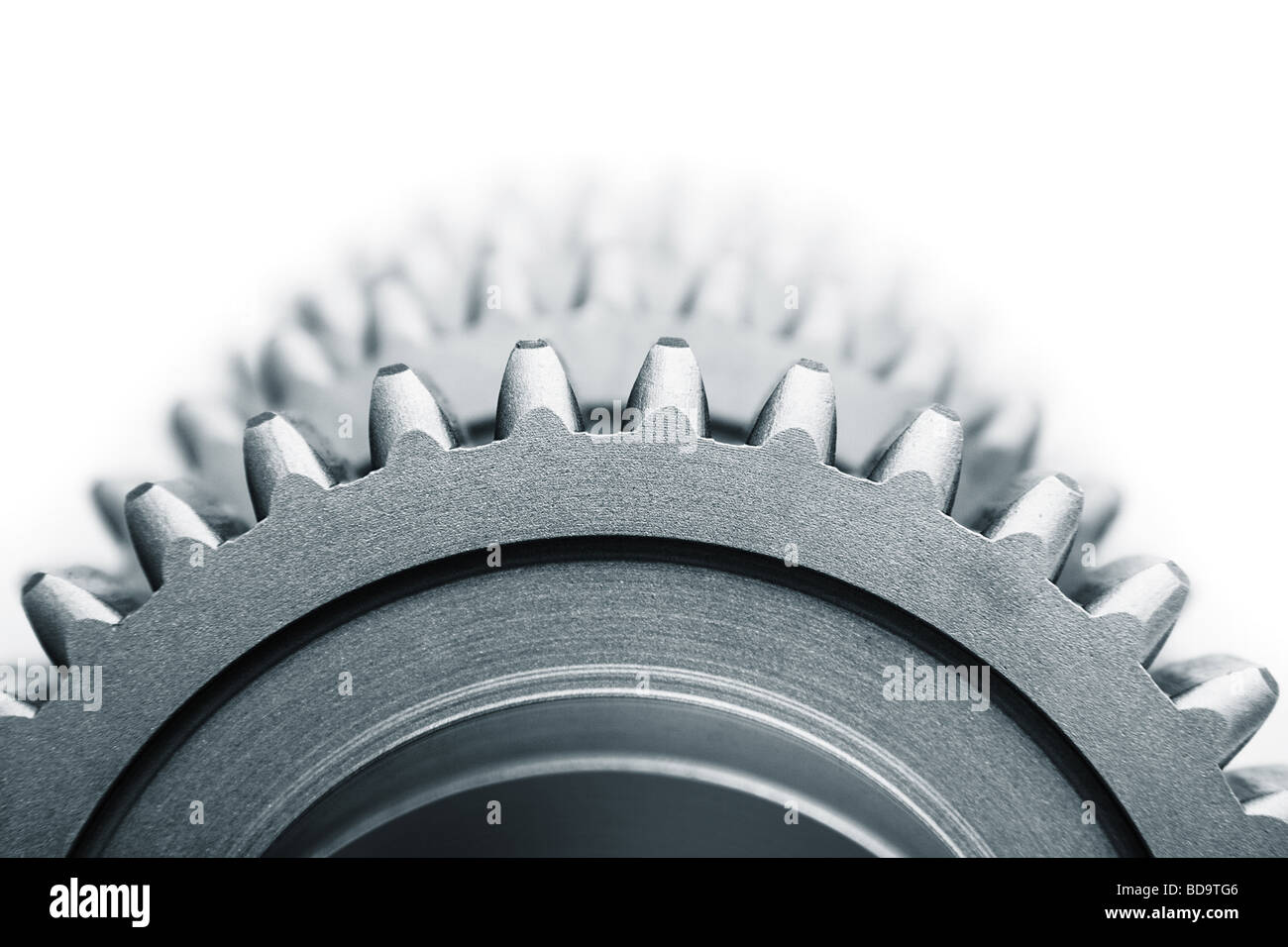 One Gear and blur gears on white background Stock Photo - Alamy