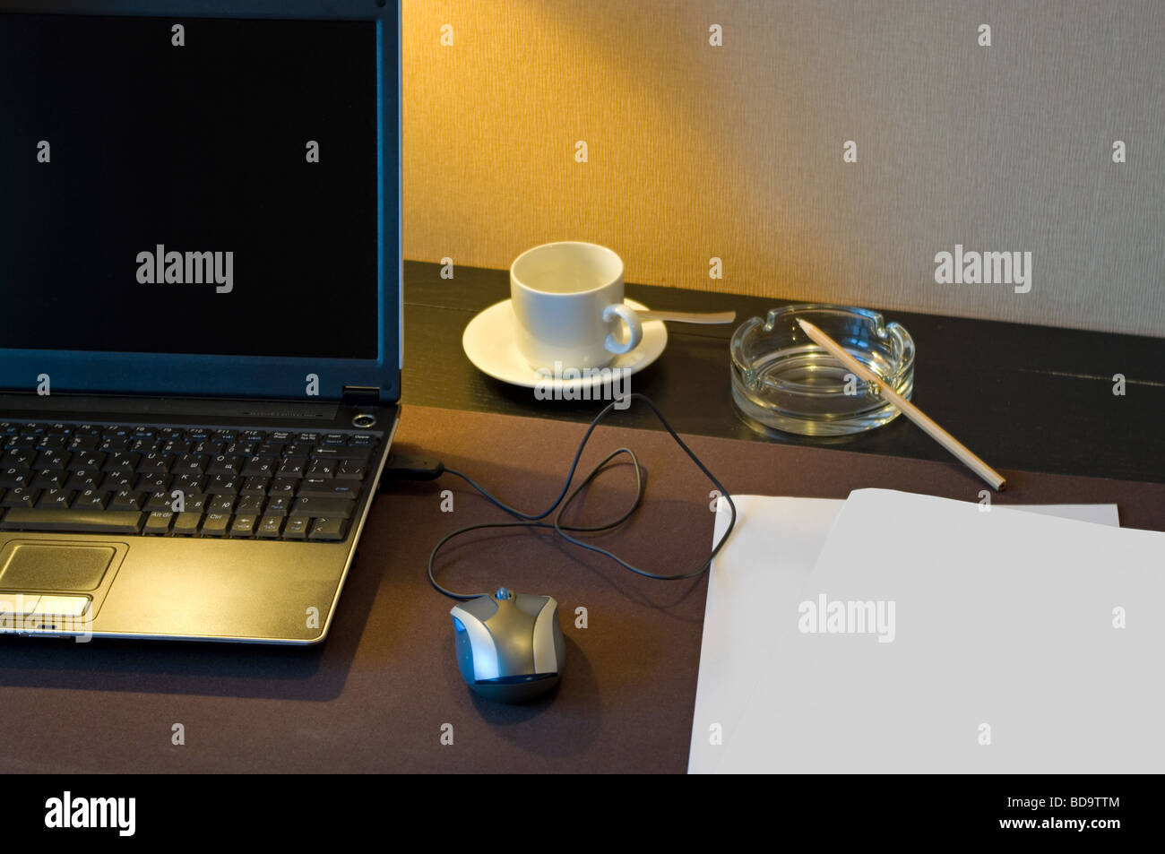 Workplace with computer, mouse, papers, cup and clear ashtray Stock ...