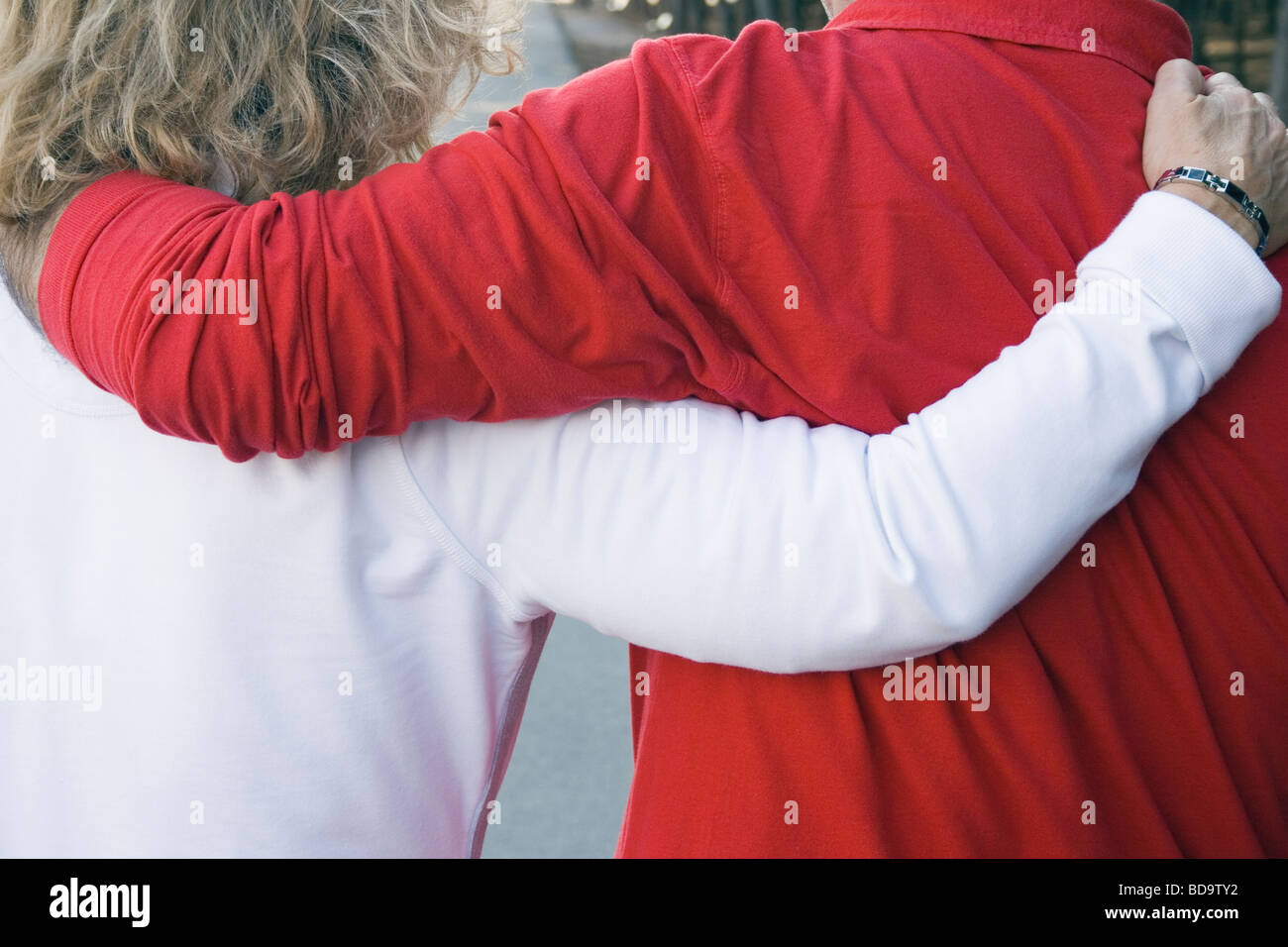 Couple with their arms around each other Stock Photo - Alamy