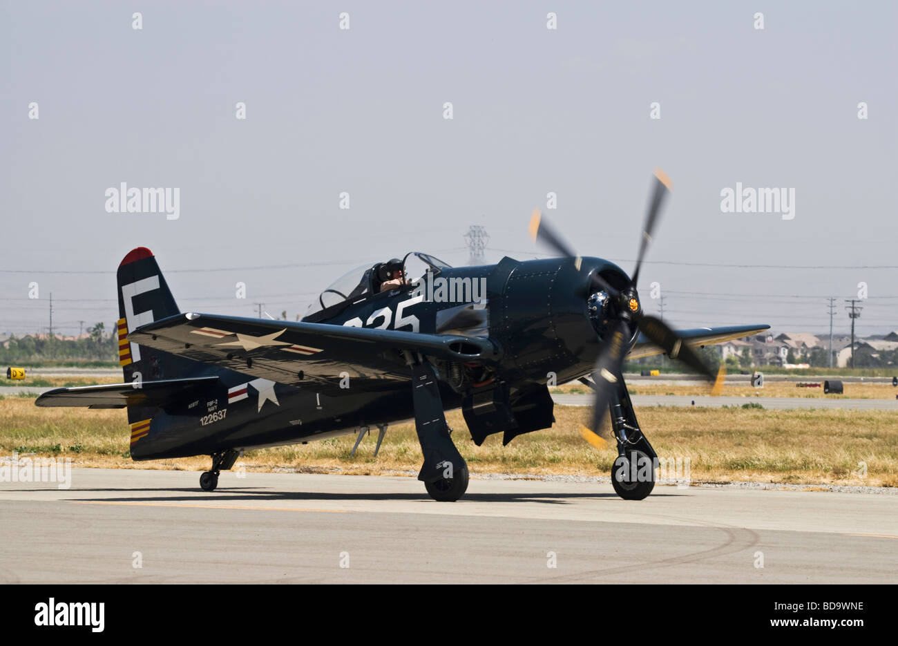 A Grumman F8F Bearcat taxis on the runway after flying at an air show ...