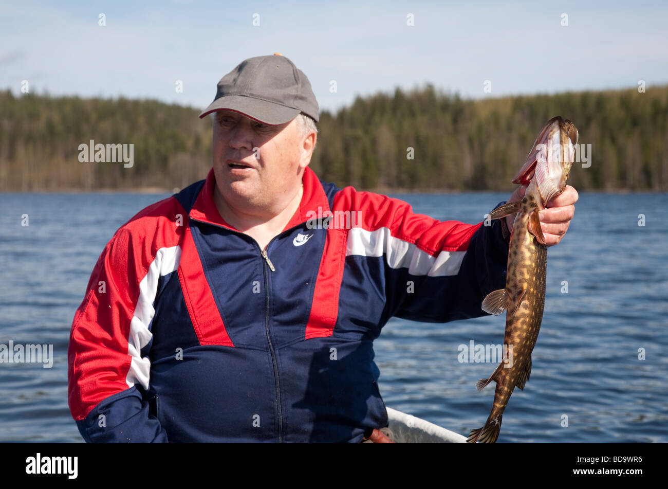 Fisherman holding northern pike hi-res stock photography and images - Alamy