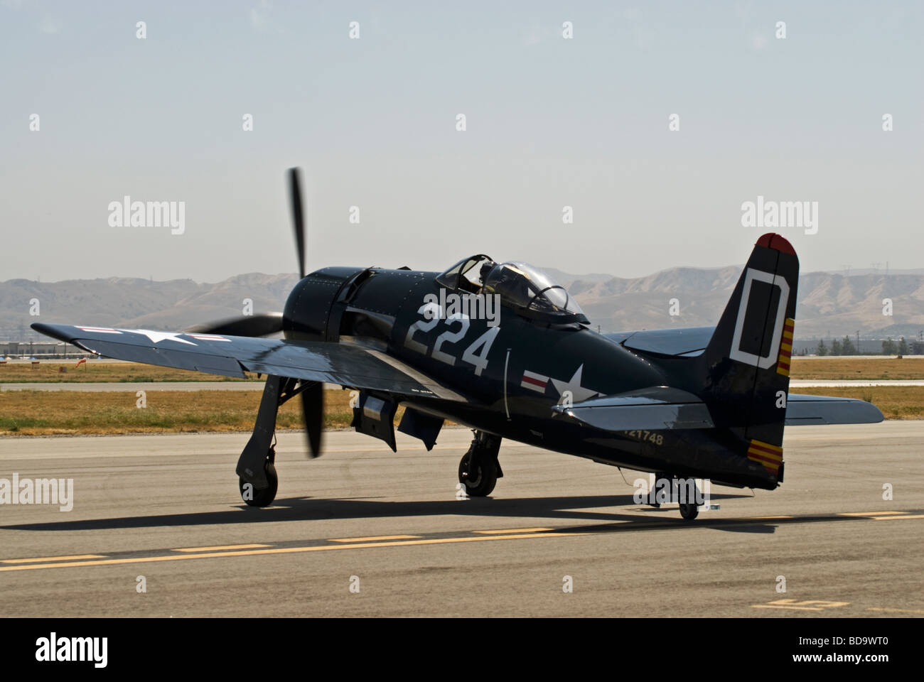 A Grumman F8F Bearcat taxis on the runway after flying at an air show ...