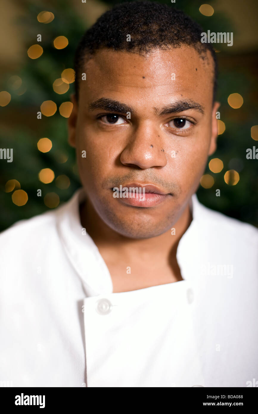 A young handsome chef poses in the lobby of his restaurant Stock Photo ...