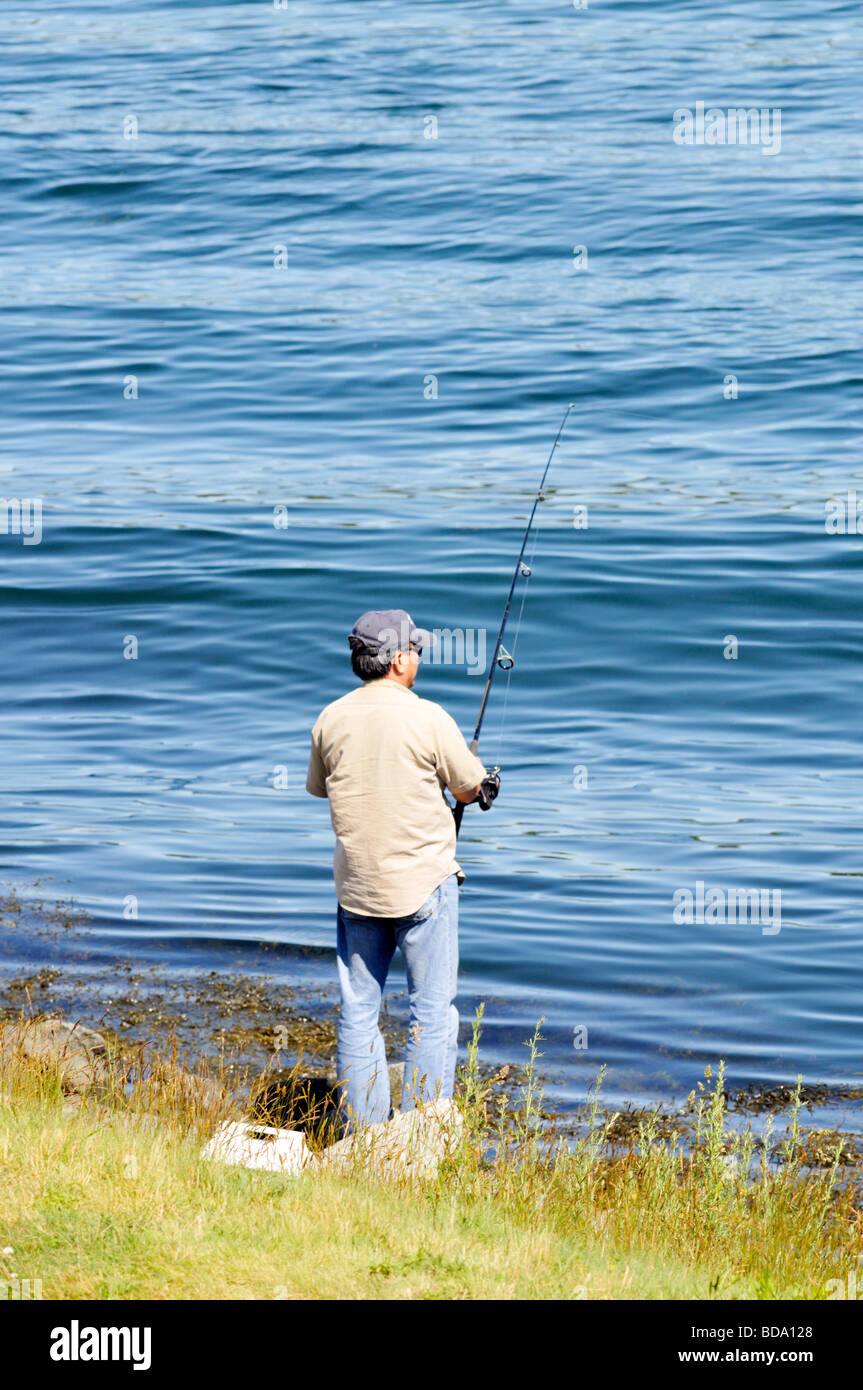Man fishing alone from Cape Cod Canal. Cape Cod, Massachusetts USA ...