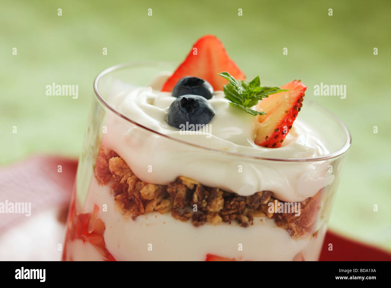 Strawberry yogurt parfait with granola in a glass Stock Photo - Alamy