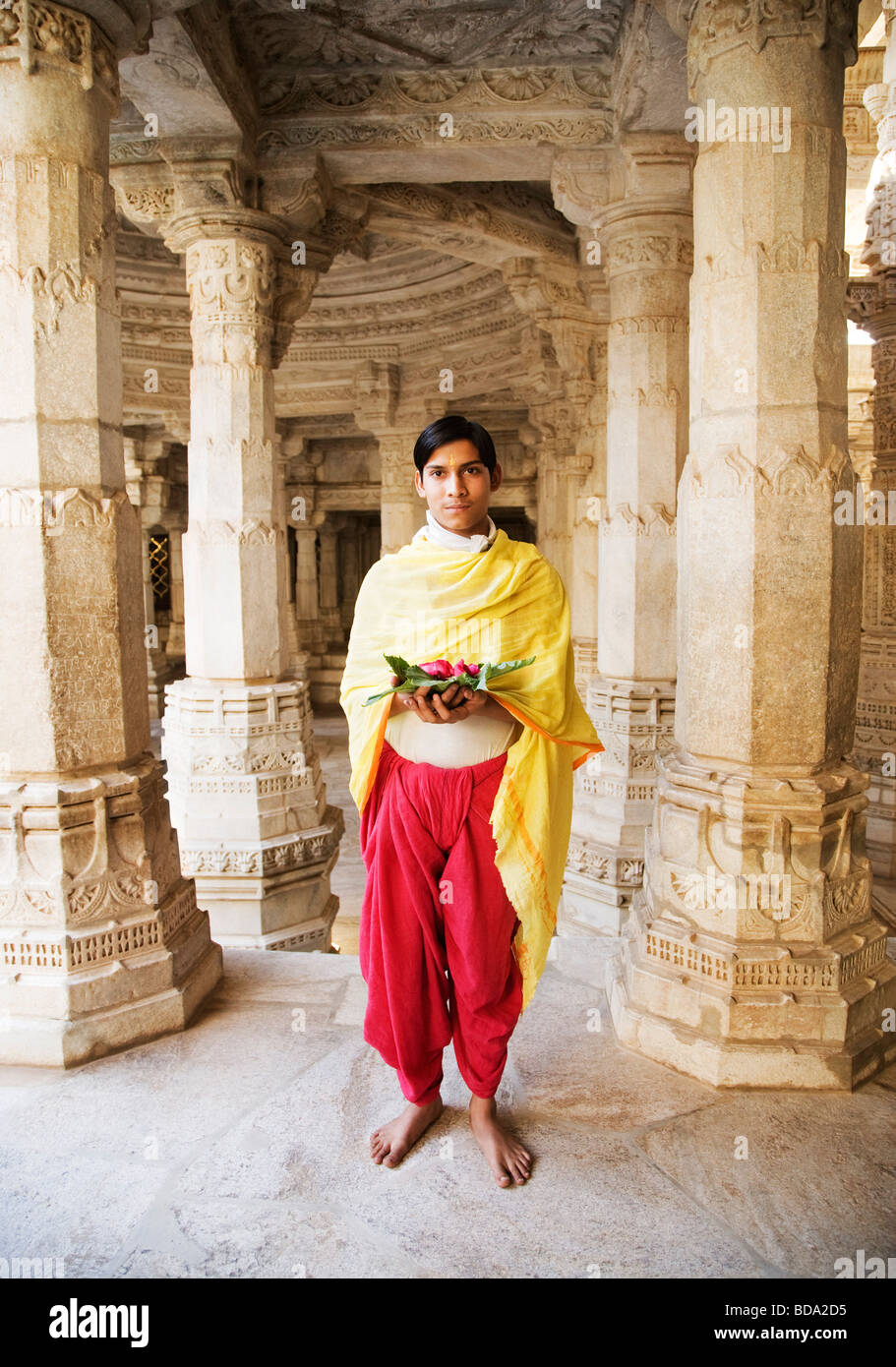 Teenage boy holding religious offering in a temple,Adinath Temple,Jain ...