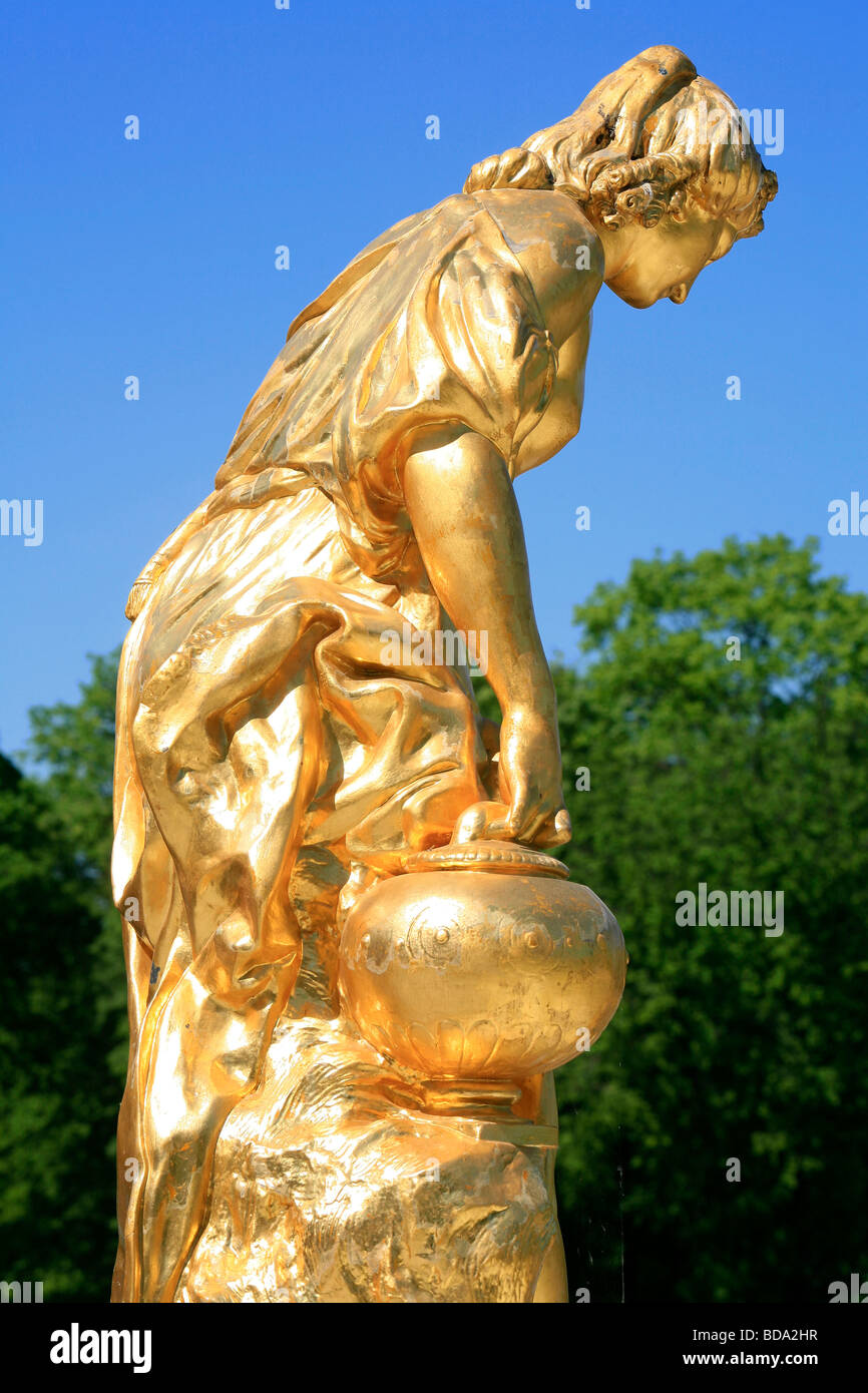 Golden statue of a lady carrying water at the Grand Cascade of the 18th ...